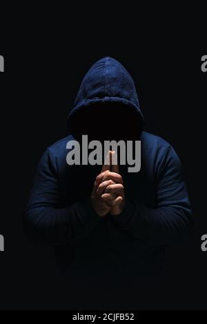 A dangerous looking man hidden in a dark forest Stock Photo - Alamy
