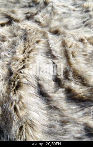 Gray fake fur vertical. Wolf similar faux fur made of synthetic fibers ...
