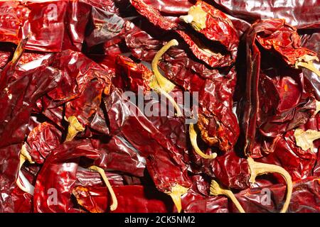 A closeup shot of dried red chili peppers on a string Stock Photo - Alamy