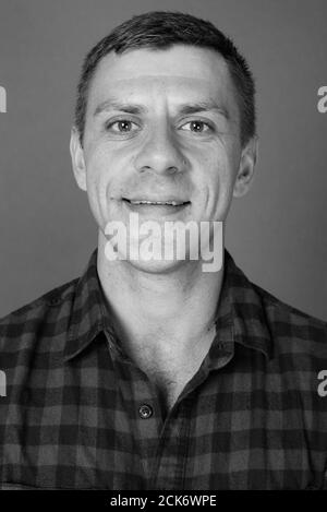 Handsome man with short hair against gray background Stock Photo - Alamy