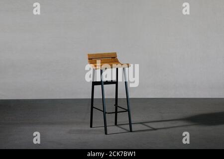 Closeup of a concave bar stool, loft-style Stock Photo - Alamy