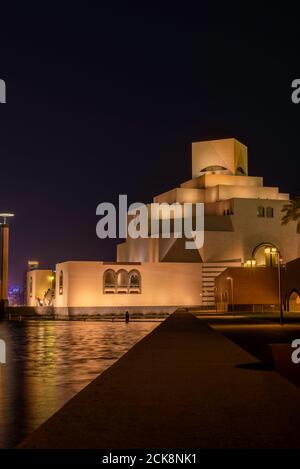 Doha Qatar skyline at night showing skyscrapers and lights reflected in ...