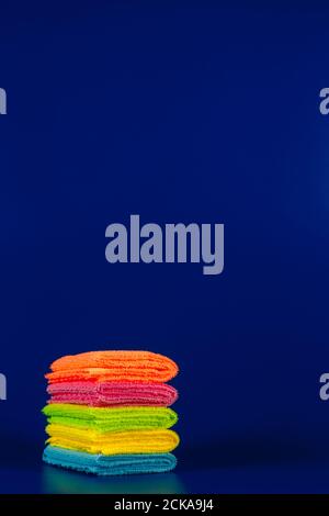 different color rags on a blue background Stock Photo - Alamy