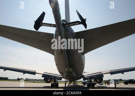 The refueling boom of a KC-46 Pegasus moves towards the universal ...