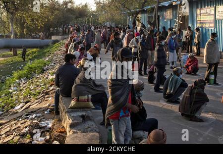 Homeless people wait for food during the lockdown imposed to contain ...