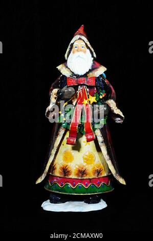 Tin Father Christmas on a black background Stock Photo - Alamy