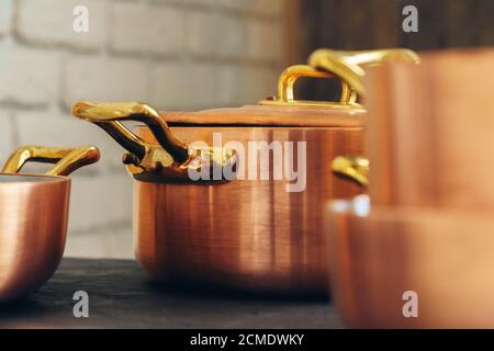 Clean copper cookware in kitchen close up Stock Photo - Alamy