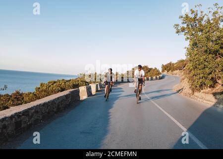 Two professional male cyclists riding their racing bicycles in the ...