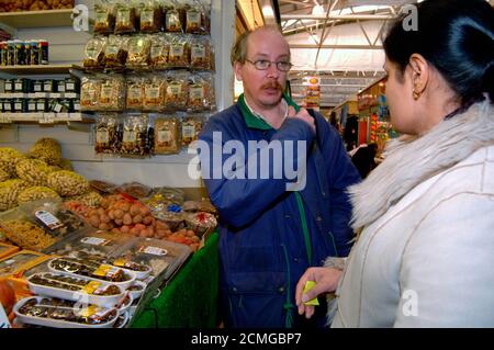 Group of men with learning disabilities shopping with carer; Bradford ...