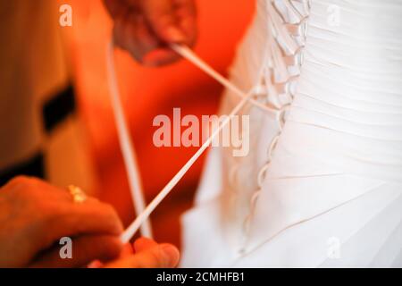 dressing the bride, lacing the bodice dress. High quality photo Stock ...