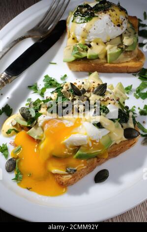 Portion of avocado toast with poached egg Stock Photo - Alamy