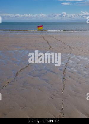 Lifeguard warniing flags on the beach at Port Eynon on the Gower ...