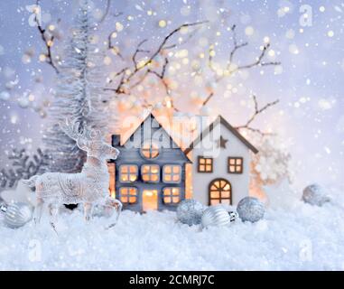 Christmas composition with decorative deer, huts and festive ...