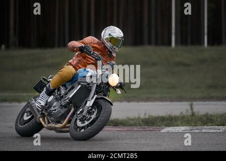 Handsome motorcyclist riding his super sport motorcycle Stock Photo - Alamy