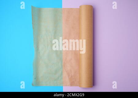 unwrapped a roll of brown parchment paper on a colored background ...