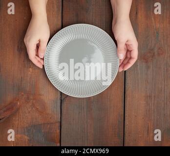 Gray empty plate (ceramic) on a gray stone background. Gray minimalism ...