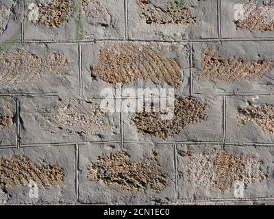 wall of yellow rectangular stones with cement, fragment of ancient ...