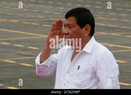 Philippine President Rodrigo Duterte salutes as he reviews the troops ...