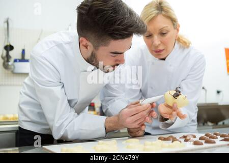 chocolatier apprentice designing a chocolate Stock Photo - Alamy