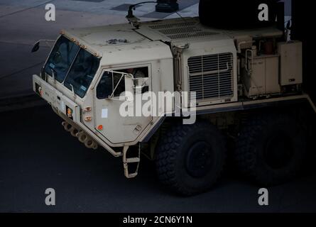 An U.S. Army Palletized Load System M1076 is pulled from a submersion ...