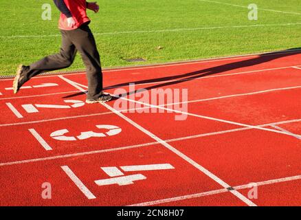 Red running racetrack on the stadium with two running legs Stock Photo ...