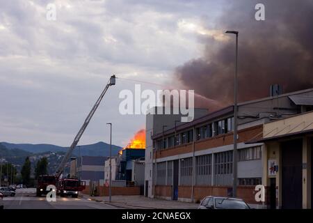 Firefighters, police, toilets, ambulances in a factory fire. Fire ...
