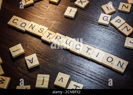 Word or phrase Construction made with scrabble letters on black table ...