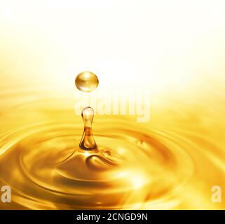 Olive or engine oil dripping on white background Stock Photo - Alamy