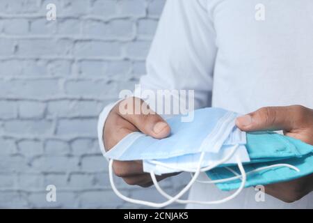 man hand holding surgical face mask, close up Stock Photo - Alamy
