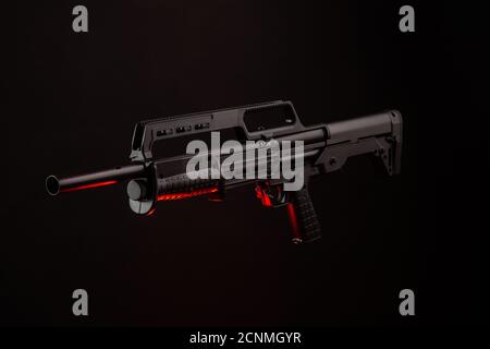 Modern tactical pump action shotgun. Pink weapon on a dark background ...