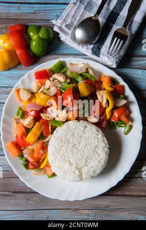 A top view of green, red, and yellow crumpled papers on pink background ...