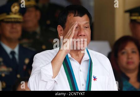 Philippine President Rodrigo Duterte salutes as he reviews the troops ...