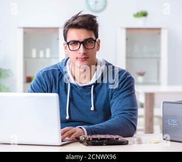 Young man mining bitcoins at home Stock Photo - Alamy