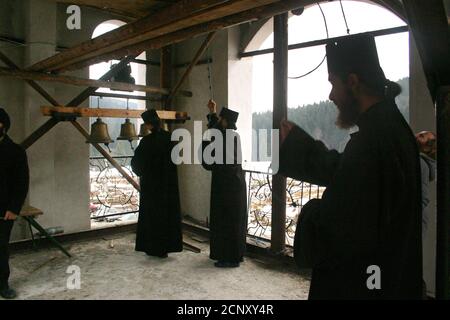 Monks ringing the bells at a Christian Orthodox Monastery in Romania ...