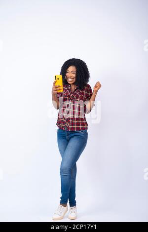 Portrait happy and surprised young lady standing isolated over grey ...