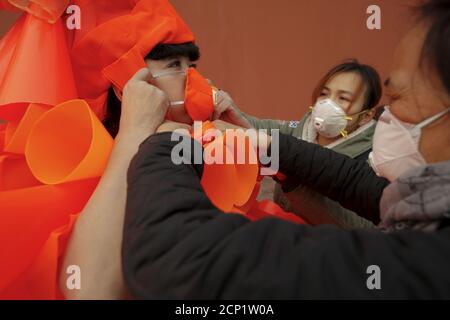 Chinese artist Kong Ning dressed in a 10-meter-long wedding gown made ...