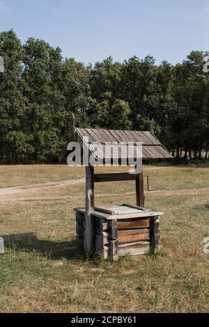 an old wooden well in a clearing Stock Photo - Alamy