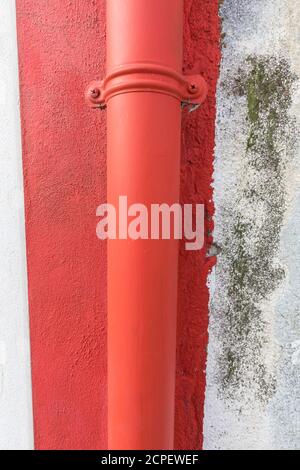 Red plumbing pipe close-up. Drainage, tubing, pipes. Red pipes of the ...