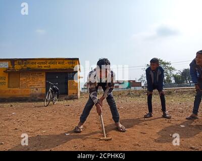 Girl playing Gilli danda traditional Indian folk game India - Model ...