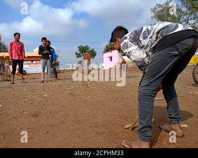 Girl playing Gilli danda traditional Indian folk game India - Model ...