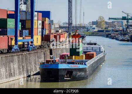 A cargo ship loads and unloads goods at the fully automated terminal of ...
