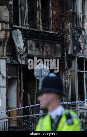 London Riots Clapham Junction burnt out shop rioting looting fire clean ...