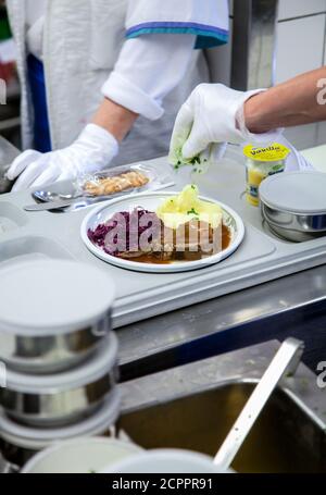 The assembly of the food trays on a conveyor belt in the dietary ...