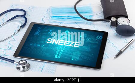 Tablet pc and doctor tools with SNEEZE inscription, coronavirus concept ...
