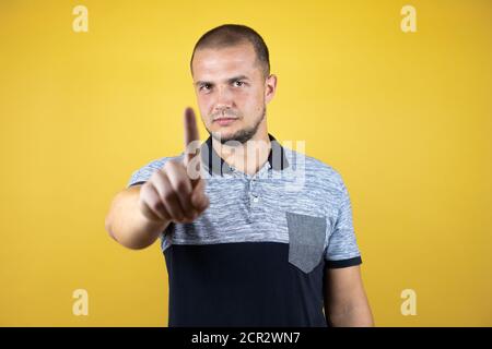 Russian man standing over insolated yellow background showing and ...