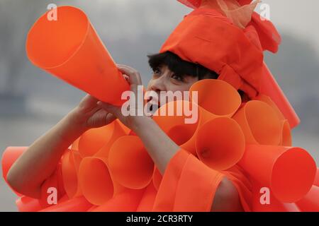 Chinese artist Kong Ning dressed in a 10-meter-long wedding gown made ...