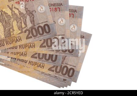 2000 Indonesian rupiah bills lies in stack on background of big semi ...