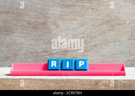 Alphabet letter in word RIP (abbreviation of rest in peace) on old red ...