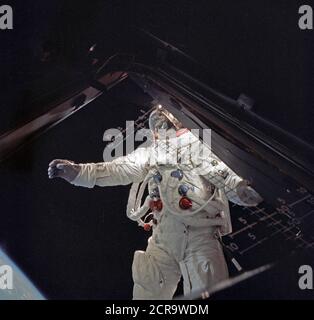 Apollo 9 astronaut Russell L. Schweickart performs a spacewalk with a ...