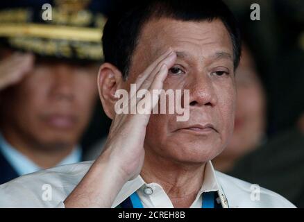 Philippine President Rodrigo Duterte salutes as he reviews the troops ...